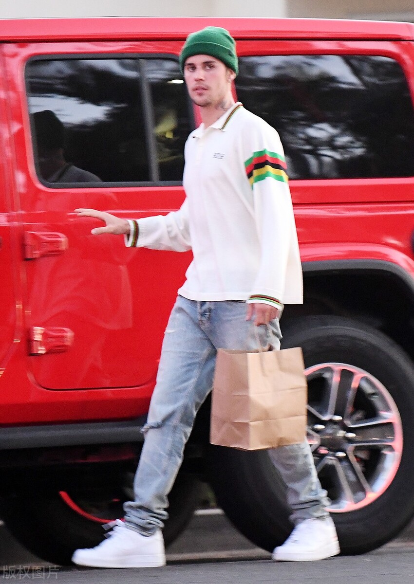 Justin Bieber is tall and handsome wearing a green knitted hat and ...