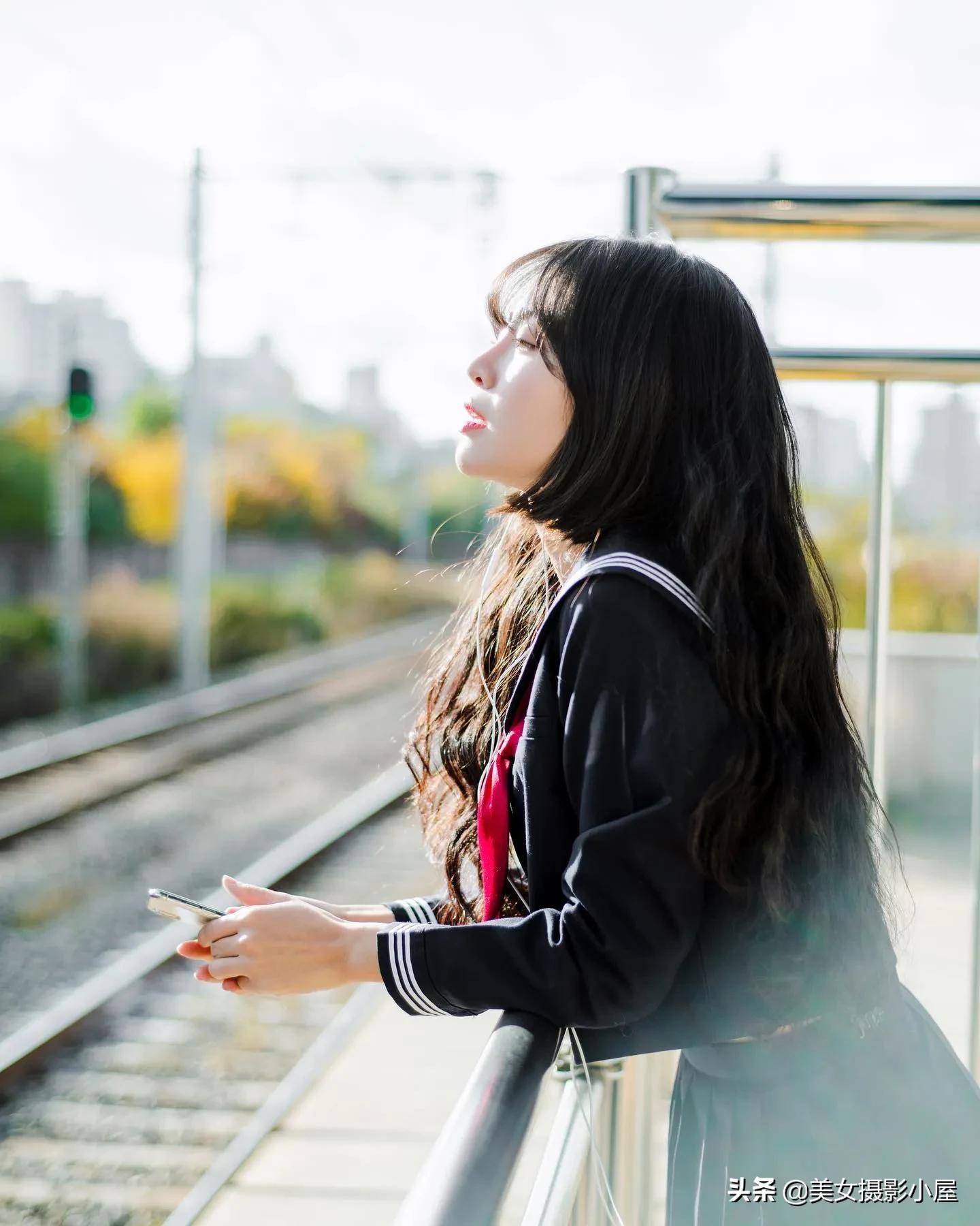 Photo exhibition of girls in sailor suits waiting at the train station ...